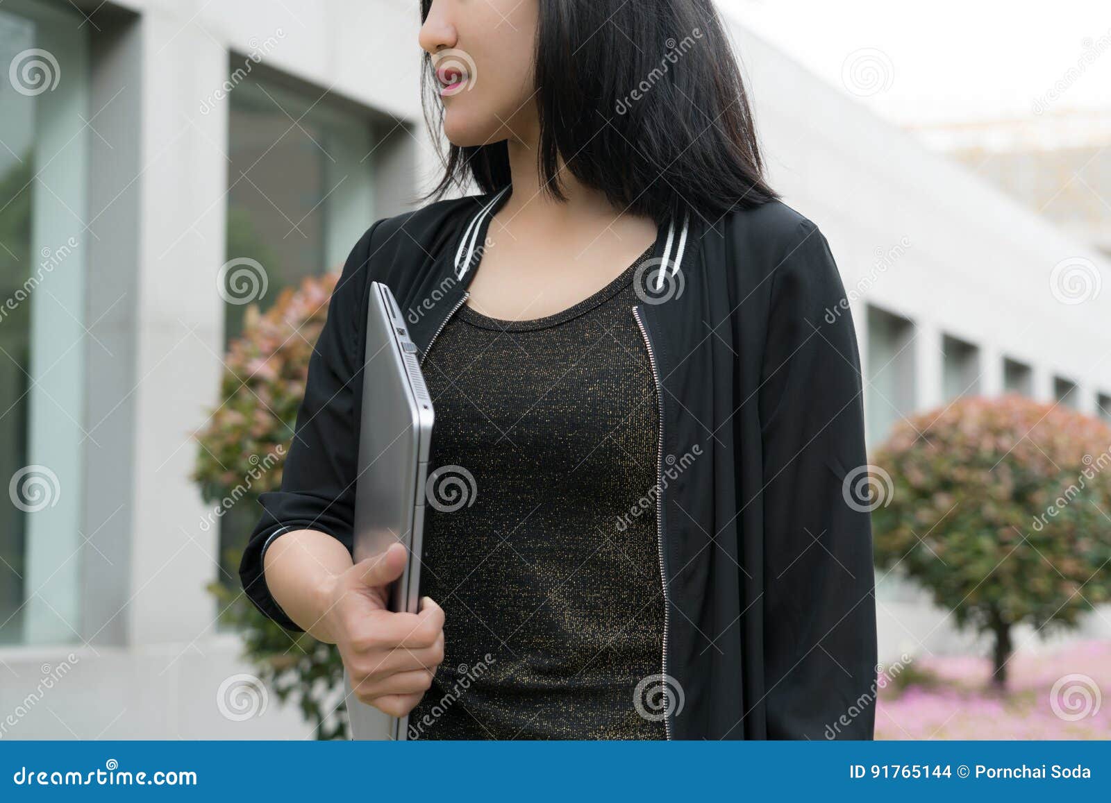 A Woman is Holding Laptop Computer while Walking Stock Photo - Image of ...