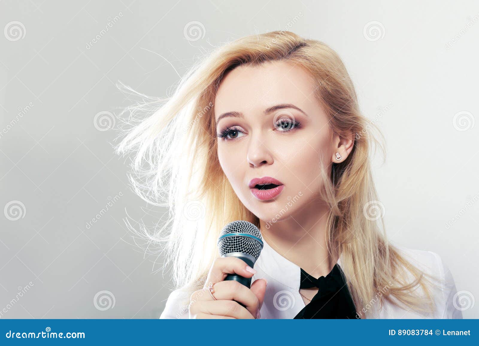Woman holding microphone stock photo. Image of gesturing - 89083784