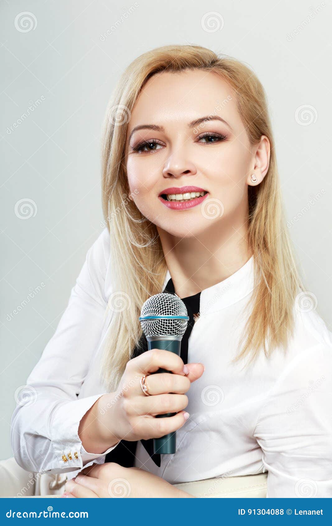 Woman holding microphone stock photo. Image of beauty - 91304088