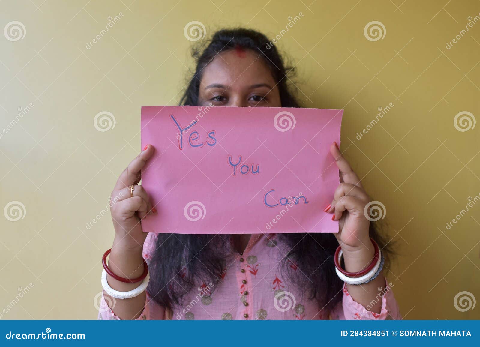 Woman Holding Paper With Text Yes You Can While Standing In Front Of