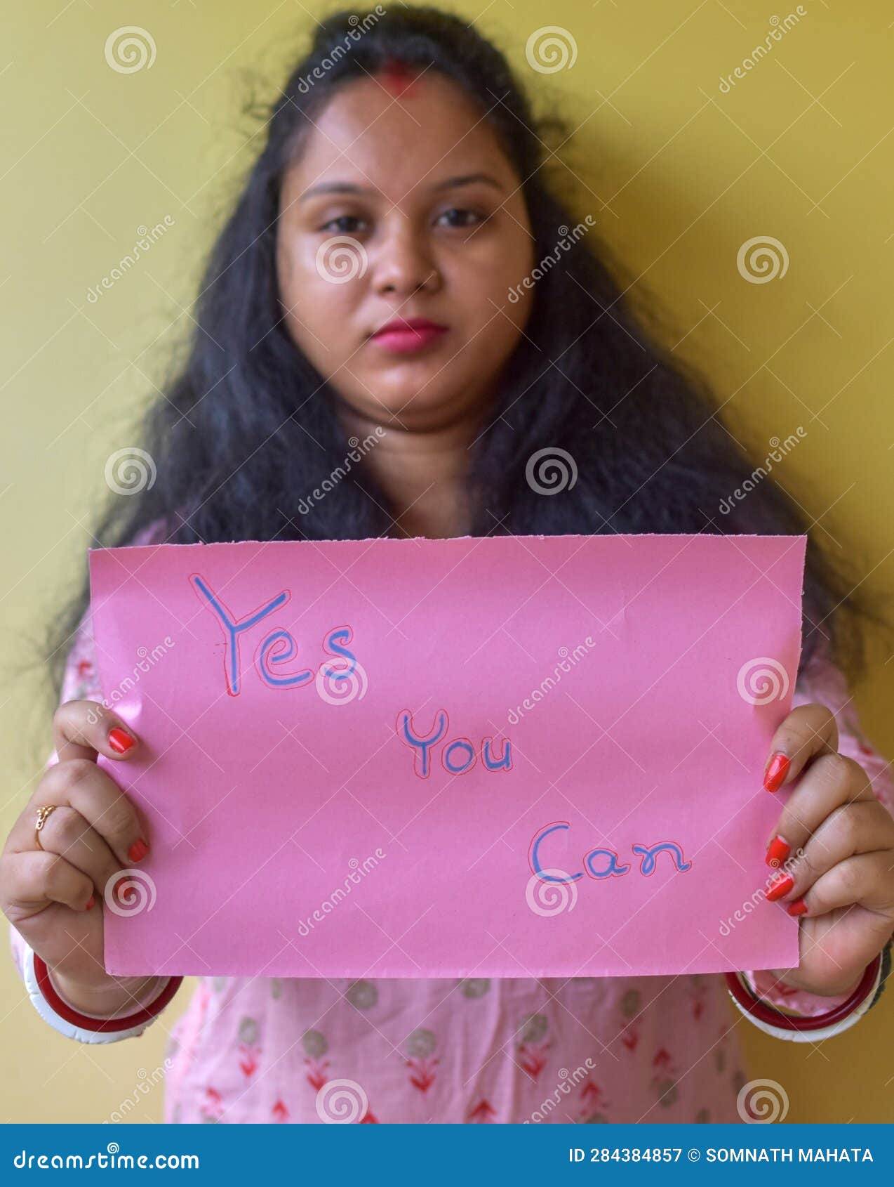 Woman Holding Paper With Text Yes You Can While Standing In Front Of