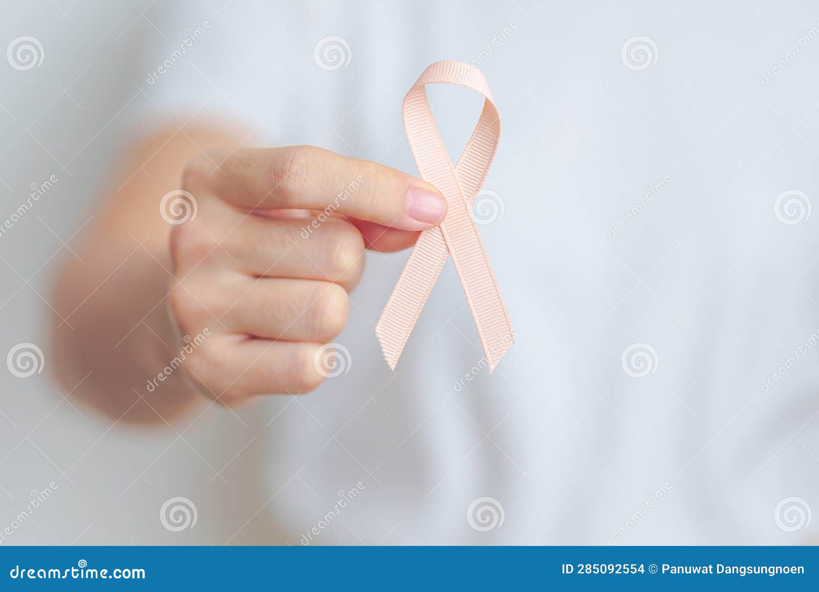 Woman Holding Peach Ribbon For September Uterine Cancer Awareness Month