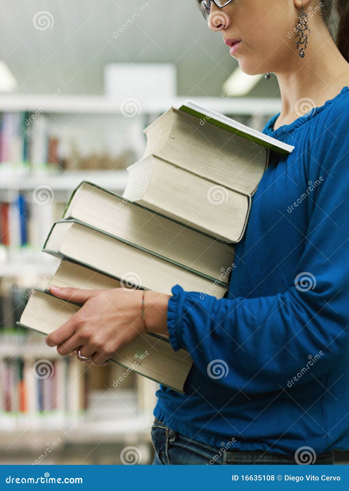 Woman Holding Pile of Books in Library Stock Photo - Image of library ...