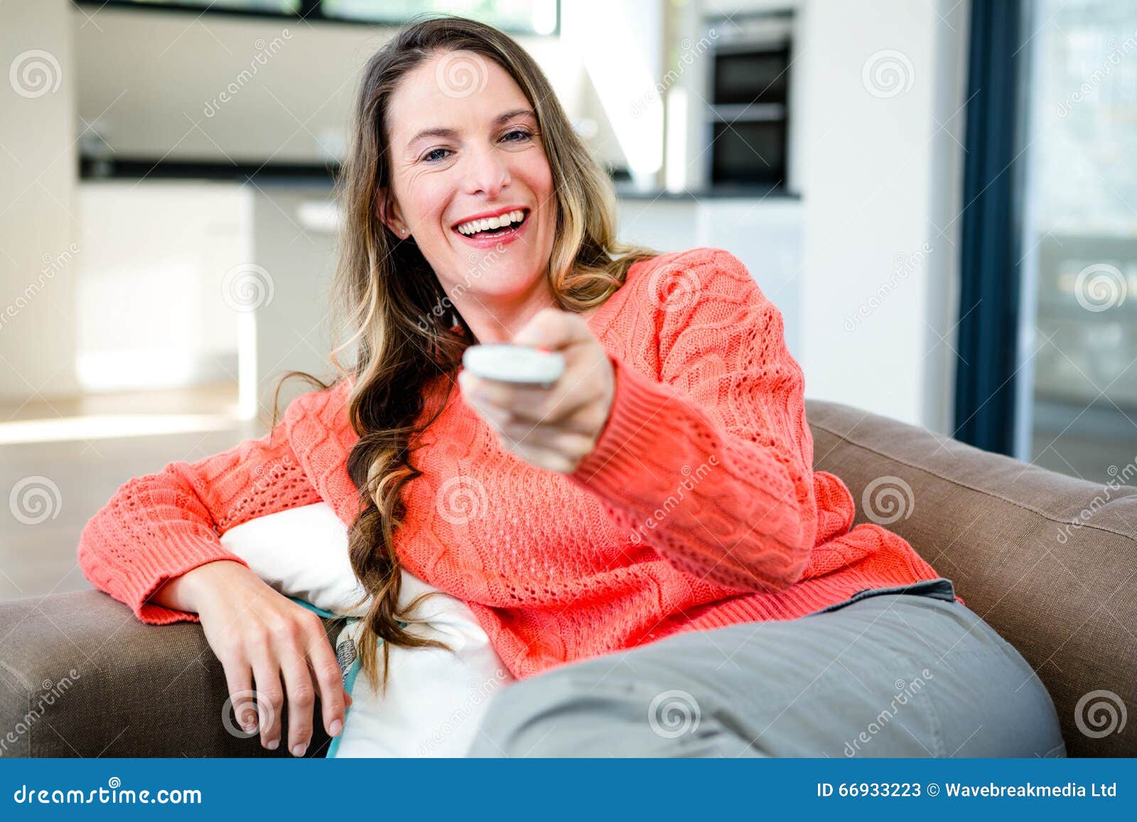 Woman Holding a Remote Control and Smiling Stock Image - Image of ...