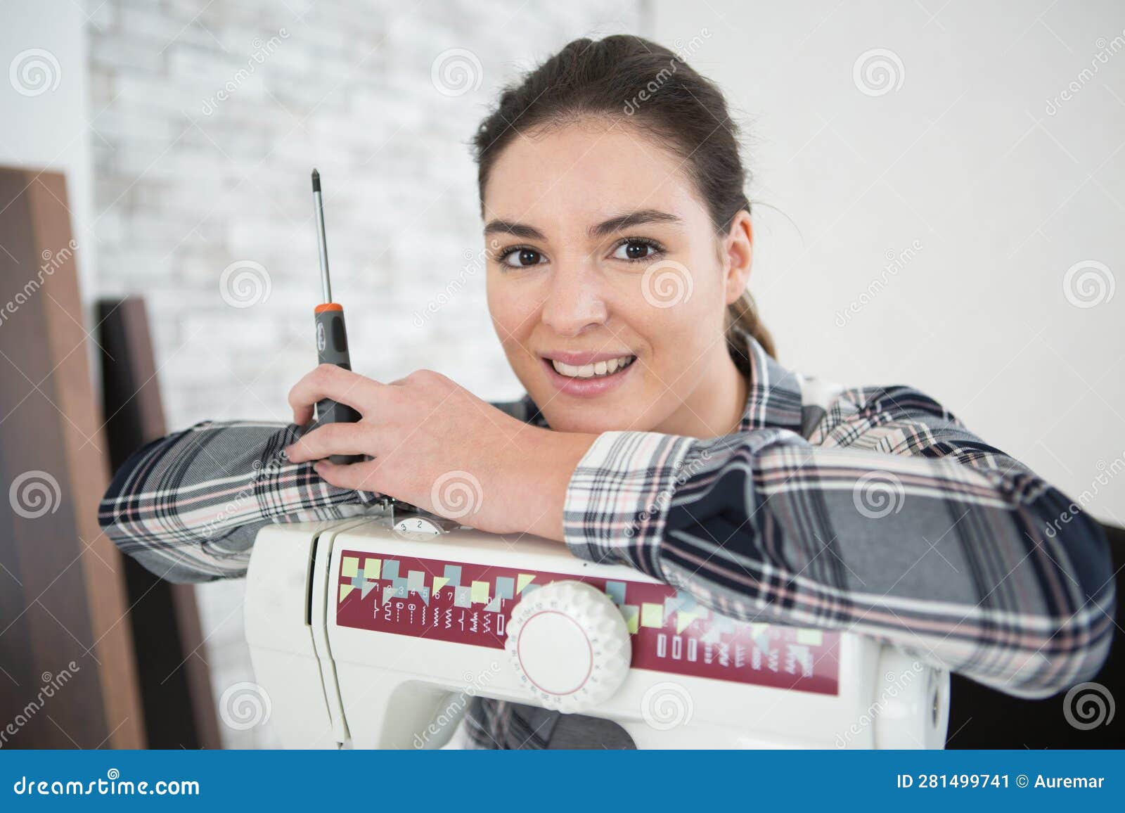 Woman Holding Screwdriver Leaning on Sewing Machine Stock Image - Image ...