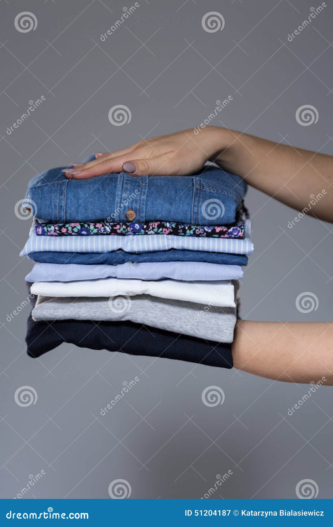 Woman Holding Stack of Clothes in Hands Stock Image - Image of store ...