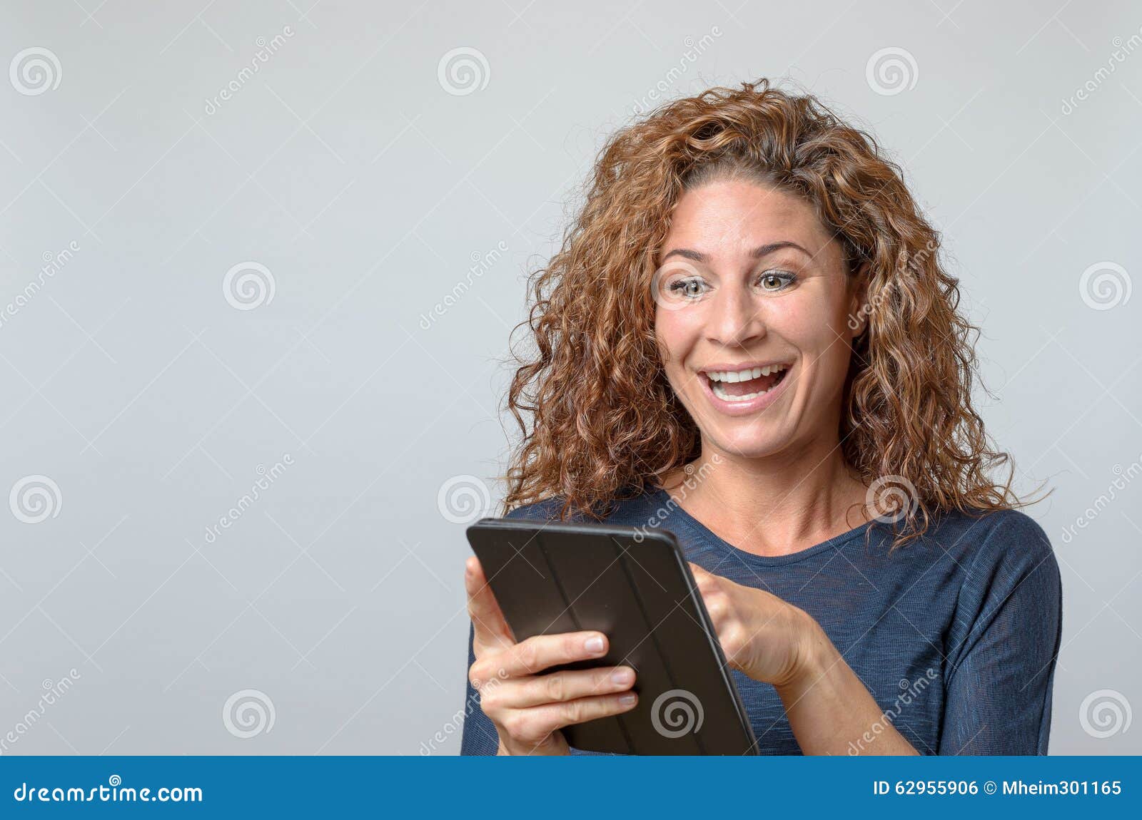 Woman Holding a tablet stock photo. Image of happy, tablet - 62955906