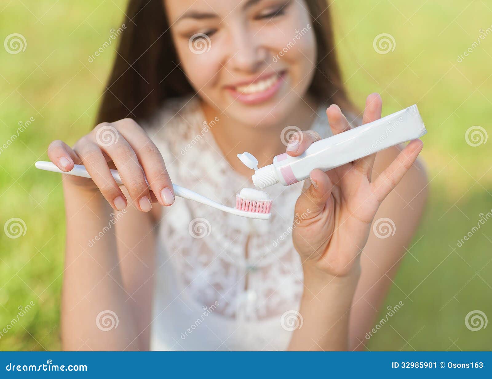 Woman Holding a Toothbrush and Placing Toothpaste on it. Stock Image ...