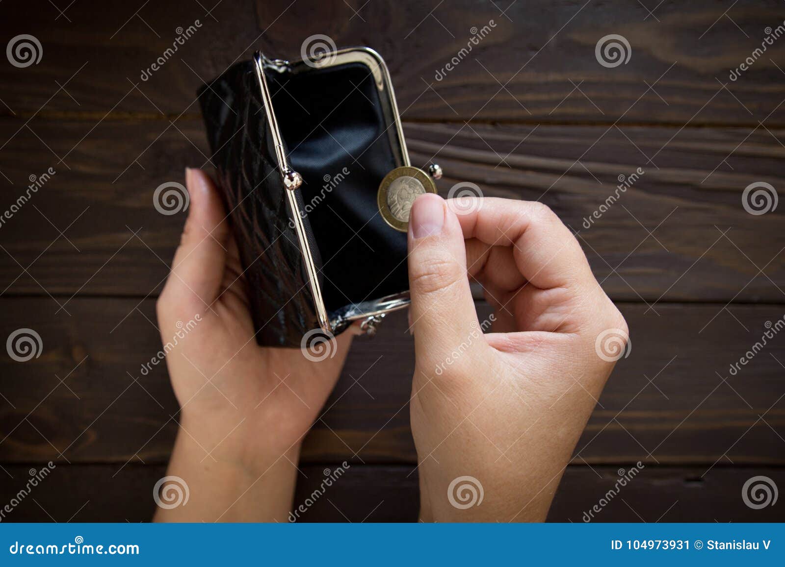 The Woman Holds the Coins Over the Old Empty Wallet. the Concept Stock ...