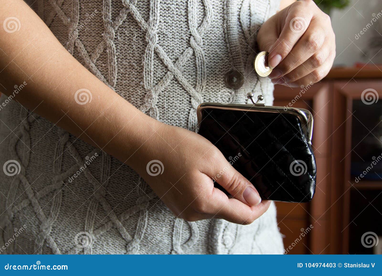 The Woman Holds the Coins Over the Old Empty Wallet. the Concept Stock ...