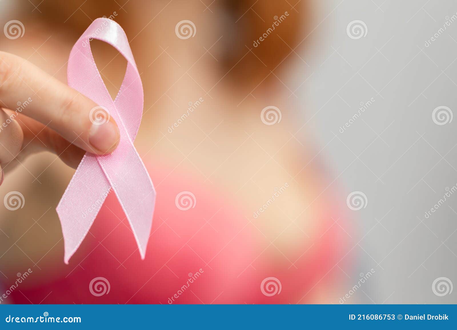 A Woman Holds A Pink Ribbon In Her Hand Symbol Of The Fight Against