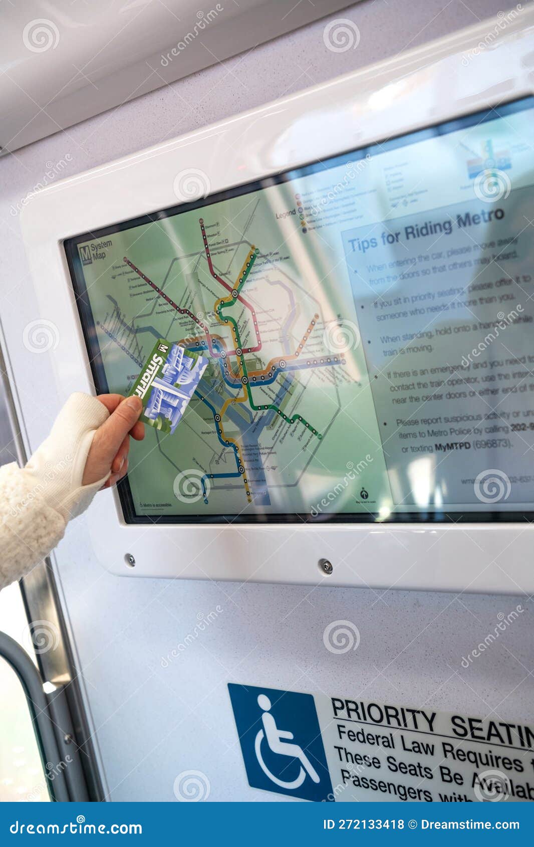 Woman Holds a SmarTrip Subway Map and Studies the Subway Map while on a ...