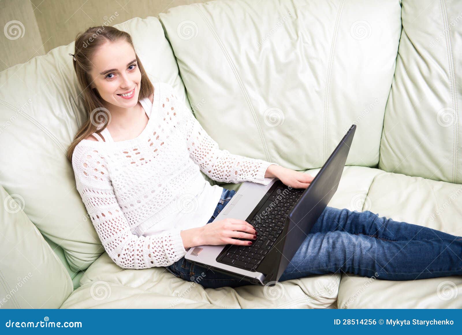 Woman at Home Sitting on Sofa and Using Her Laptop Computer Stock Photo ...