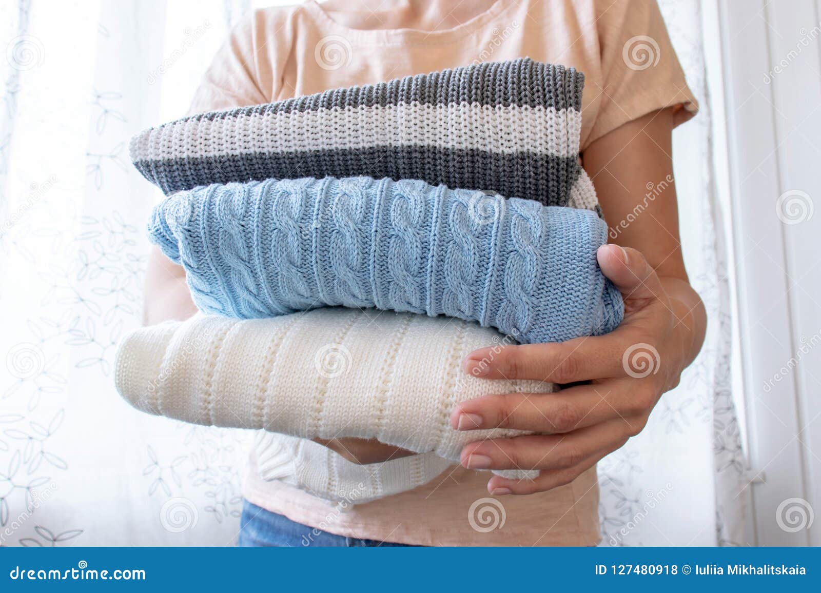 Woman, Housewife Holding a Stack of Clothes in Hands Close Up Stock ... Woman, Housewife Holding a Stack of Clothes in Hands Close Up Stock ...