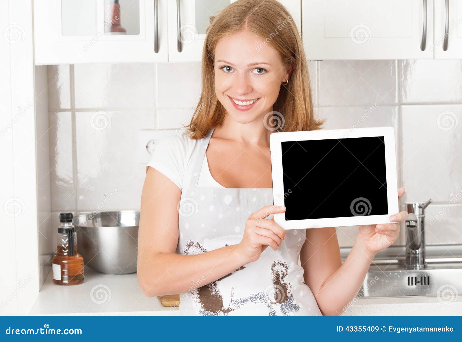 Woman Housewife in the Kitchen with an Blank Empty Tablet Computer ...