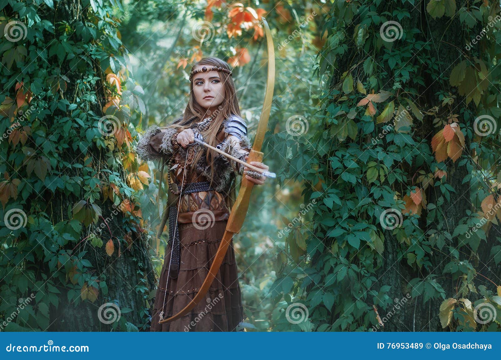 Woman Hunter with a Bow in Hand, Taking Aim at His Prey in the Forest ...