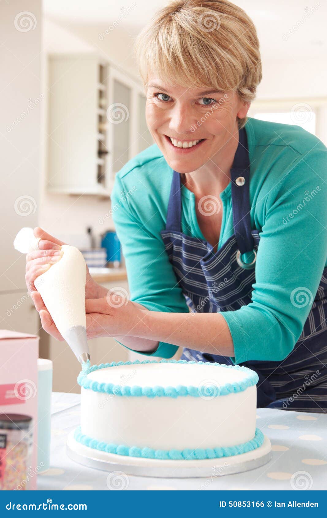 Woman Icing Birthday Cake in Kitchen at Home Stock Photo - Image of ...