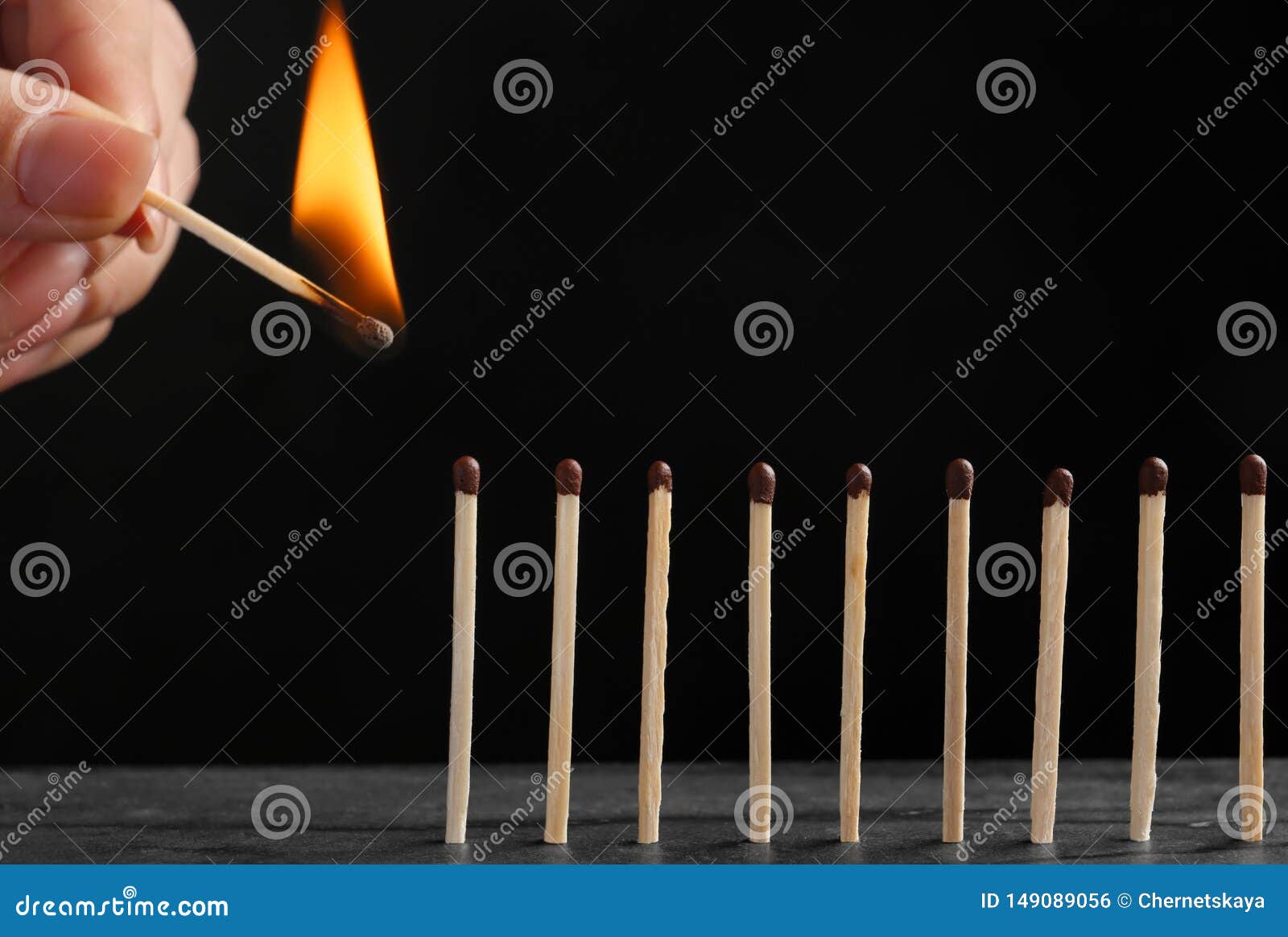 Woman Igniting Line of Matches on Table Against Dark Background. Space ...