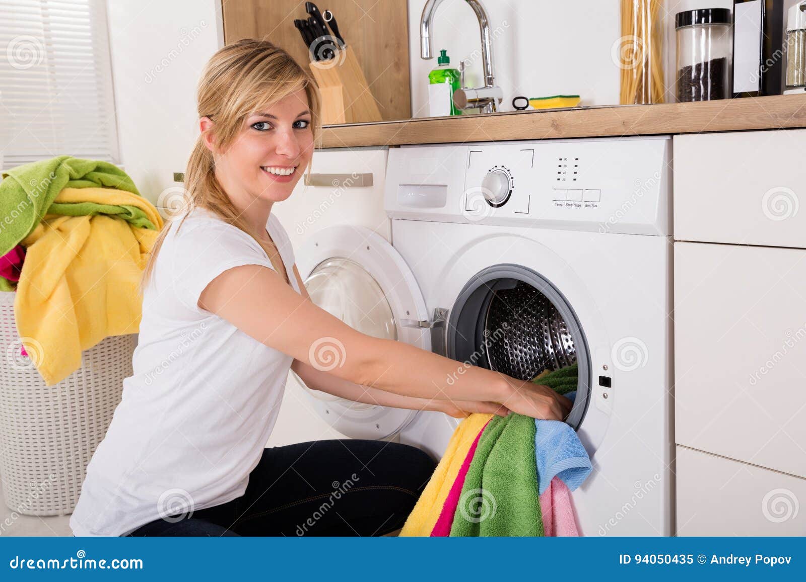 Woman Inserting Clothes in Washing Machine Stock Image - Image of ...