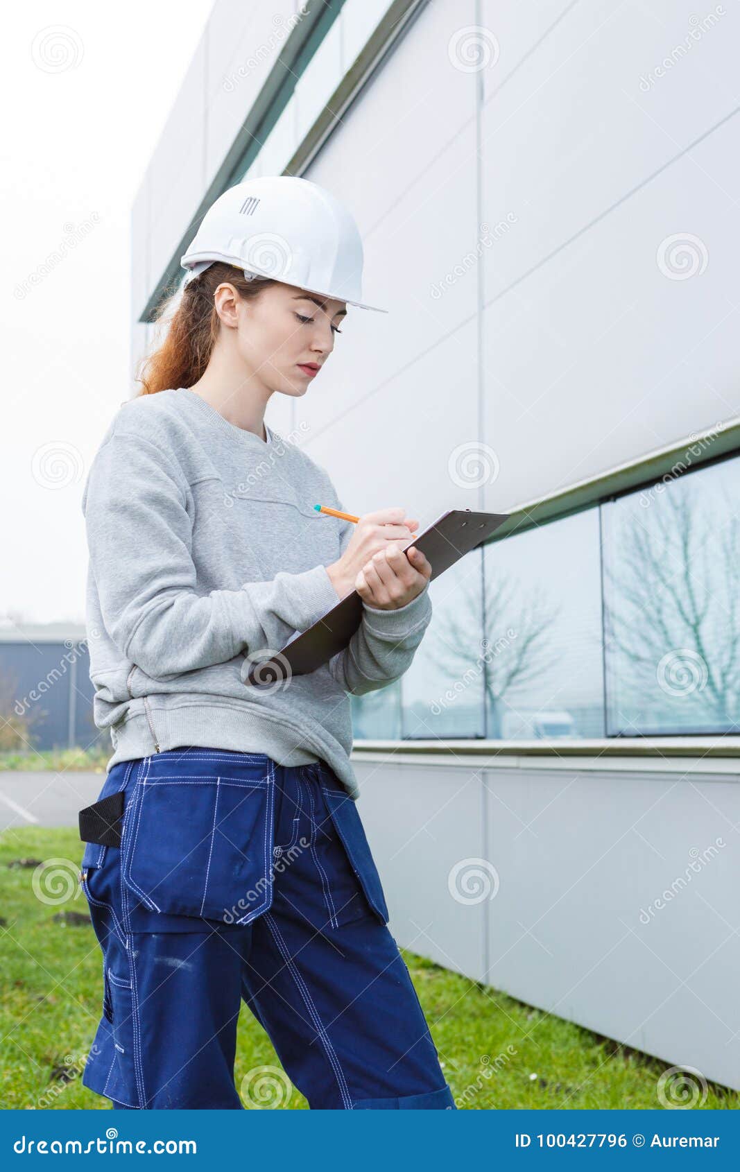 Woman Inspecting Exterior Building Stock Photo - Image of quotation ...