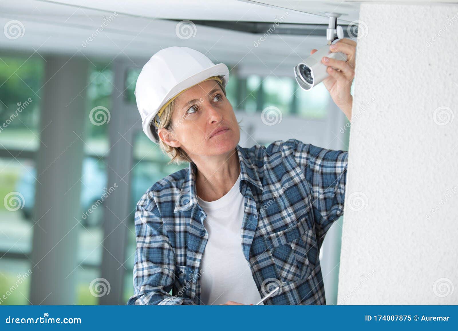 Woman Inspecting Indoor Cctv Camera Stock Image - Image of secure ...