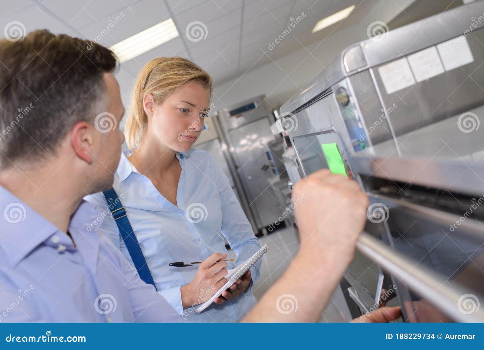 Woman Inspecting Kitchen Making Notes Stock Photo - Image of steel ...