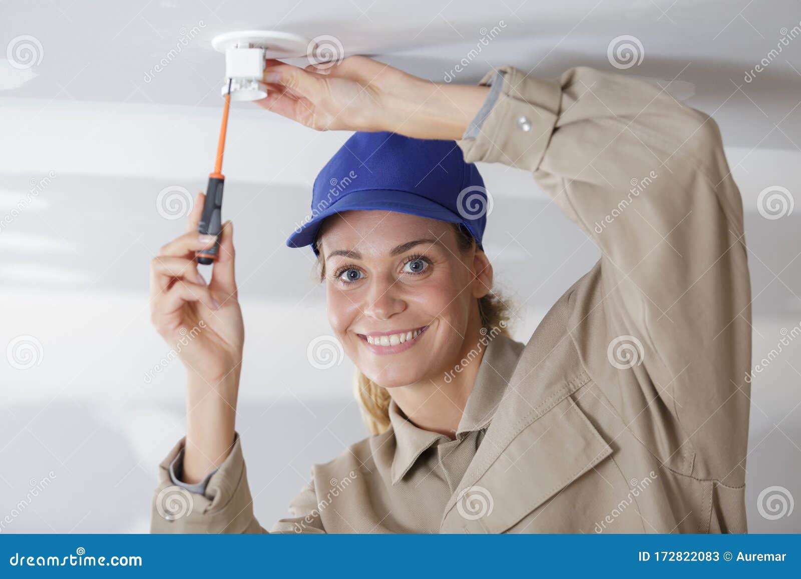 Woman Installing Light Bulb in Ceiling Stock Image - Image of home ...