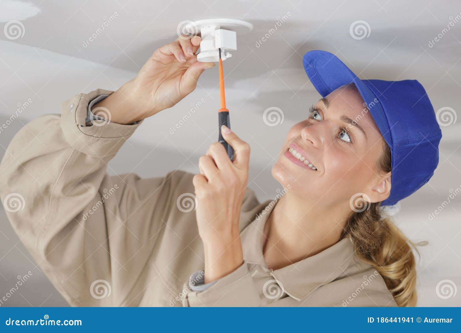 Woman Installing Light Fitting Stock Image - Image of electric, home ...