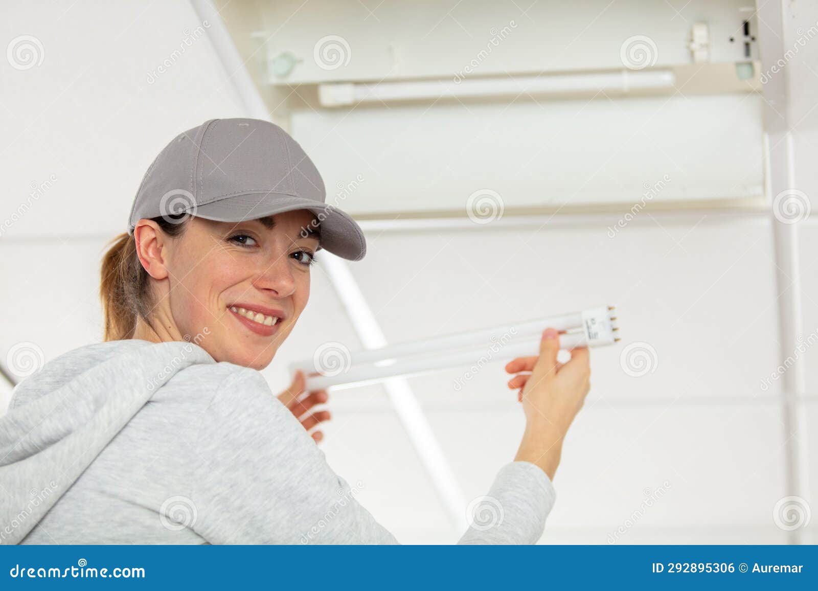 Woman Installing Replacement Fluorescent Bulb Stock Photo - Image of ...