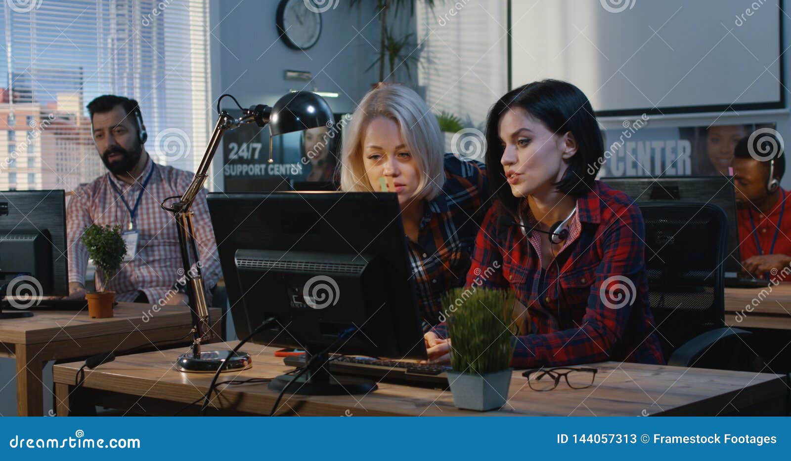 Woman Instructing Coworker at a Support Center Stock Image - Image of ...