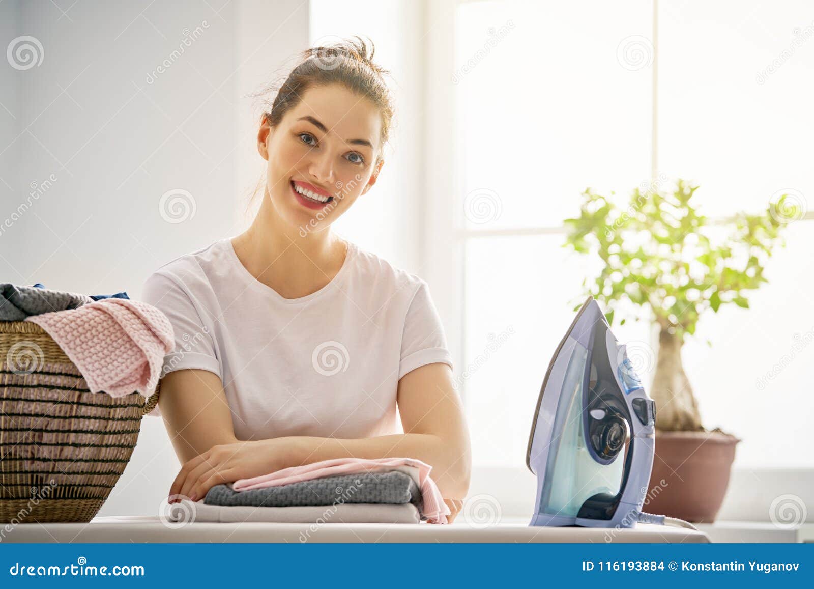 Woman is ironing at home stock photo. Image of housewife - 116193884