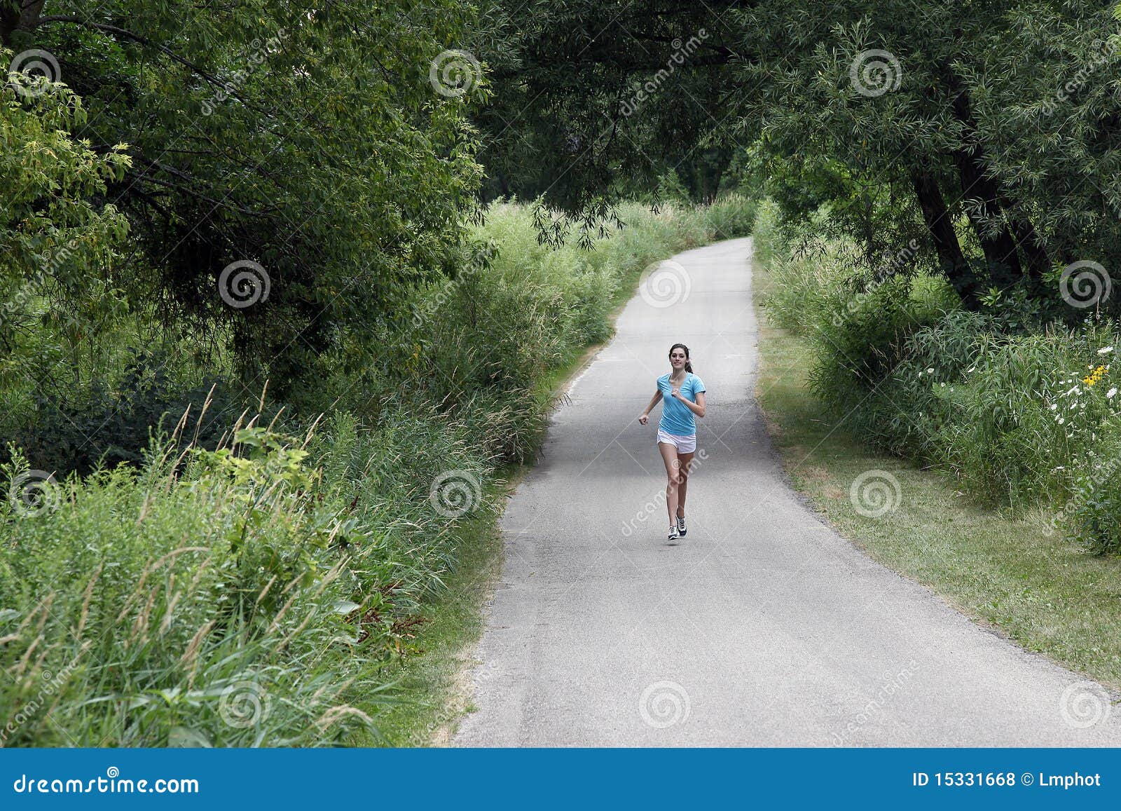 Woman Jogging Along a Pathway Stock Photo - Image of sunlight, spring ...