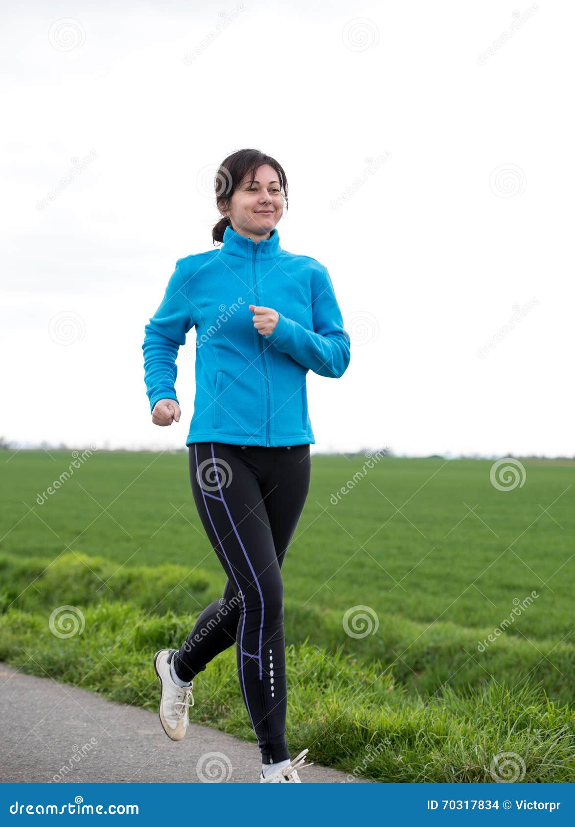 Woman jogging outdoors stock photo. Image of road, morning - 70317834