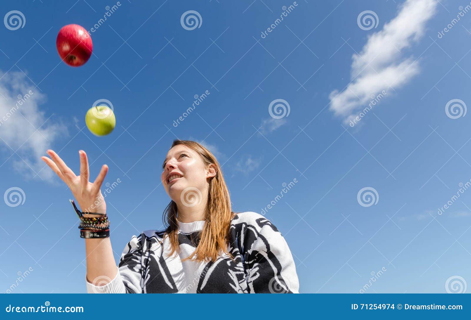 Woman juggling with apples stock photo. Image of food - 71254974