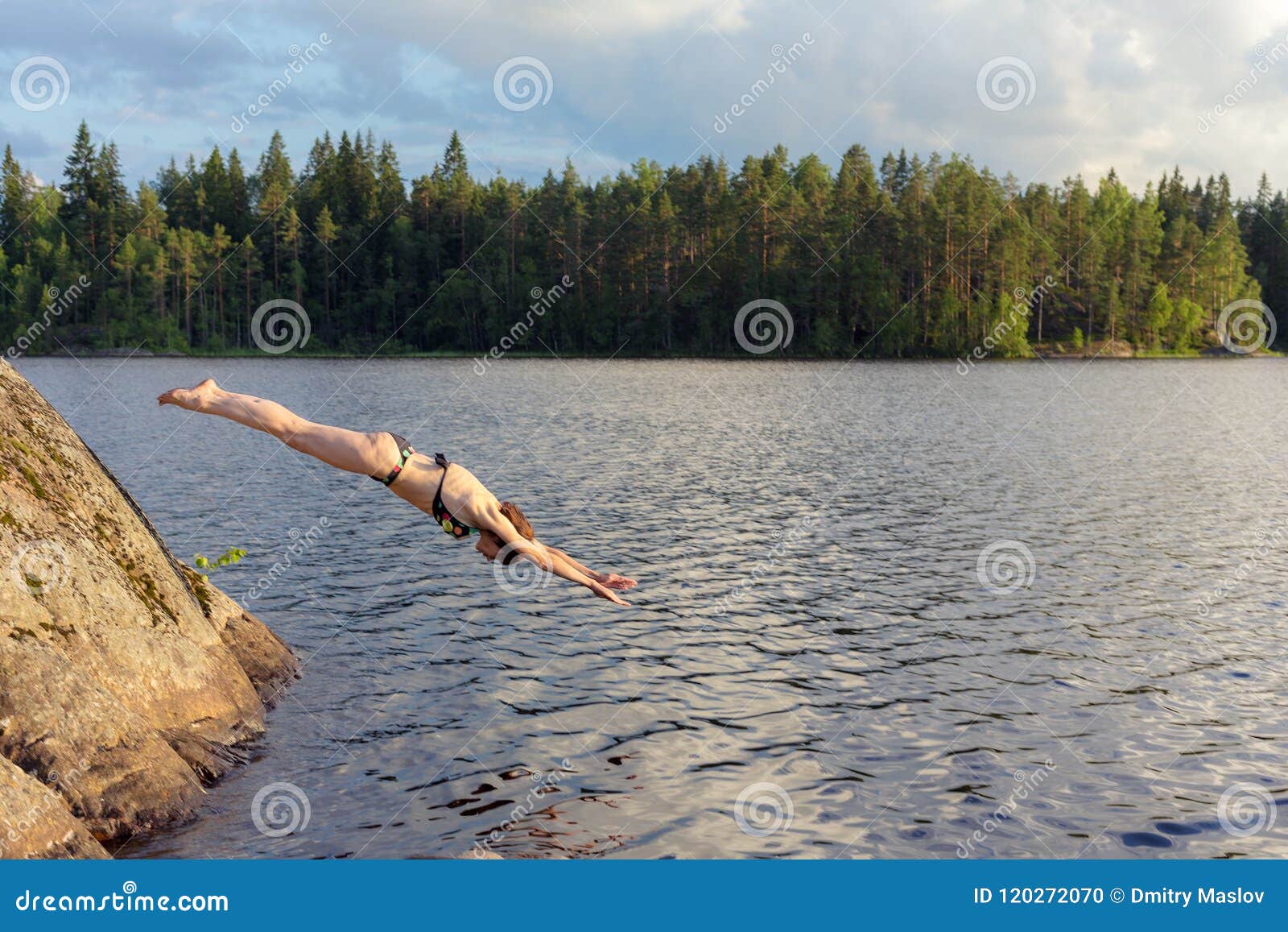 Woman jumping from a rock stock photo. Image of season - 120272070