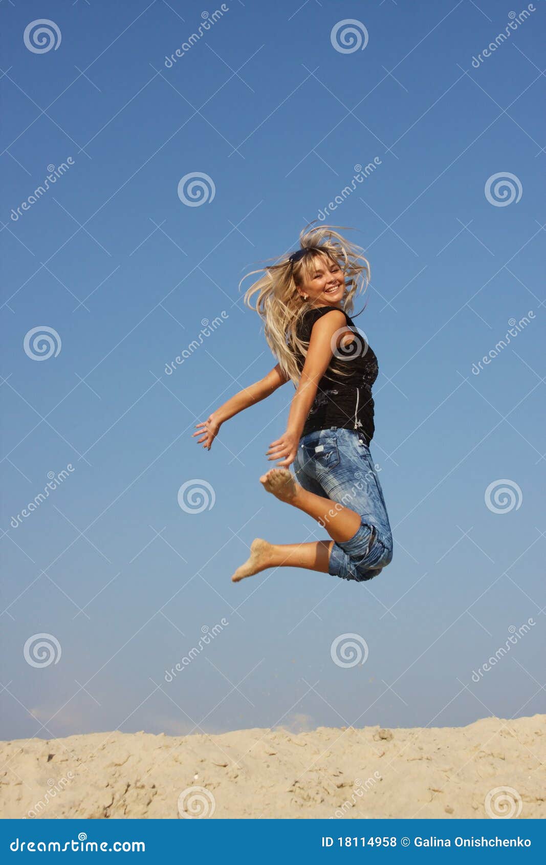 Woman jumps on a sand-pit stock photo. Image of details - 18114958