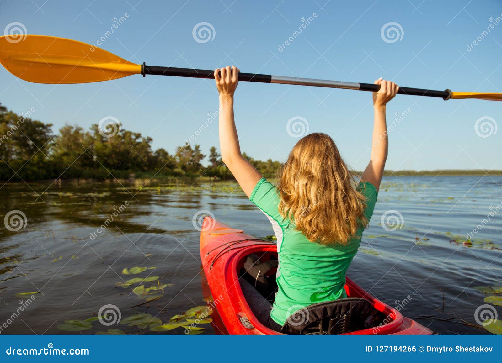 Woman in a Kayak on a River with a Raised Oar Stock Photo - Image of ...