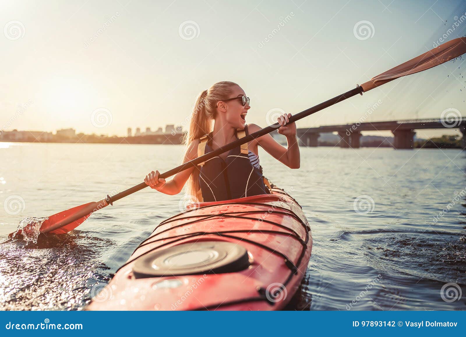 Woman kayaking on sunset stock photo. Image of exploring - 97893142