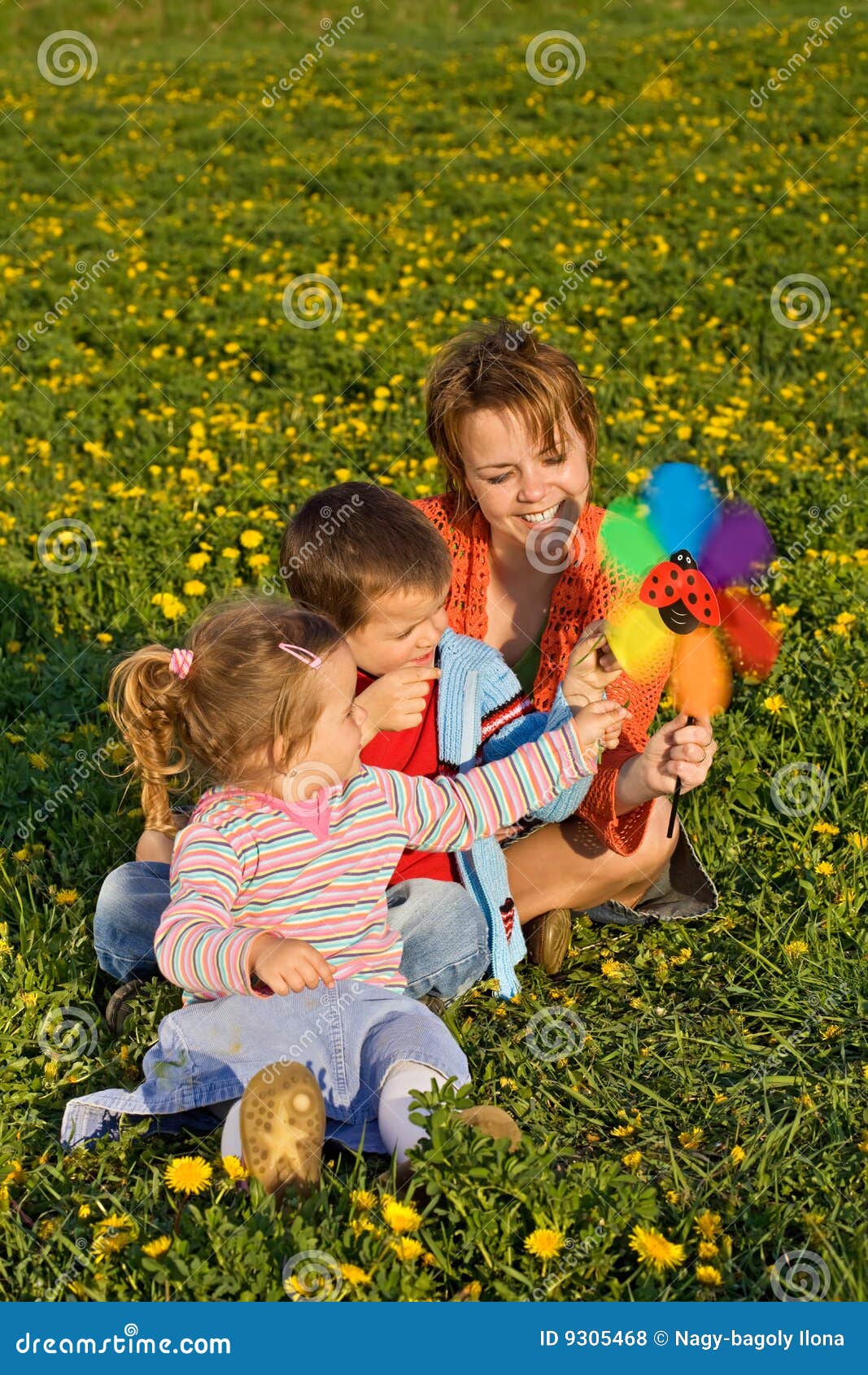 Woman and Kids Playing with a Windmill Toy Stock Photo - Image of ...