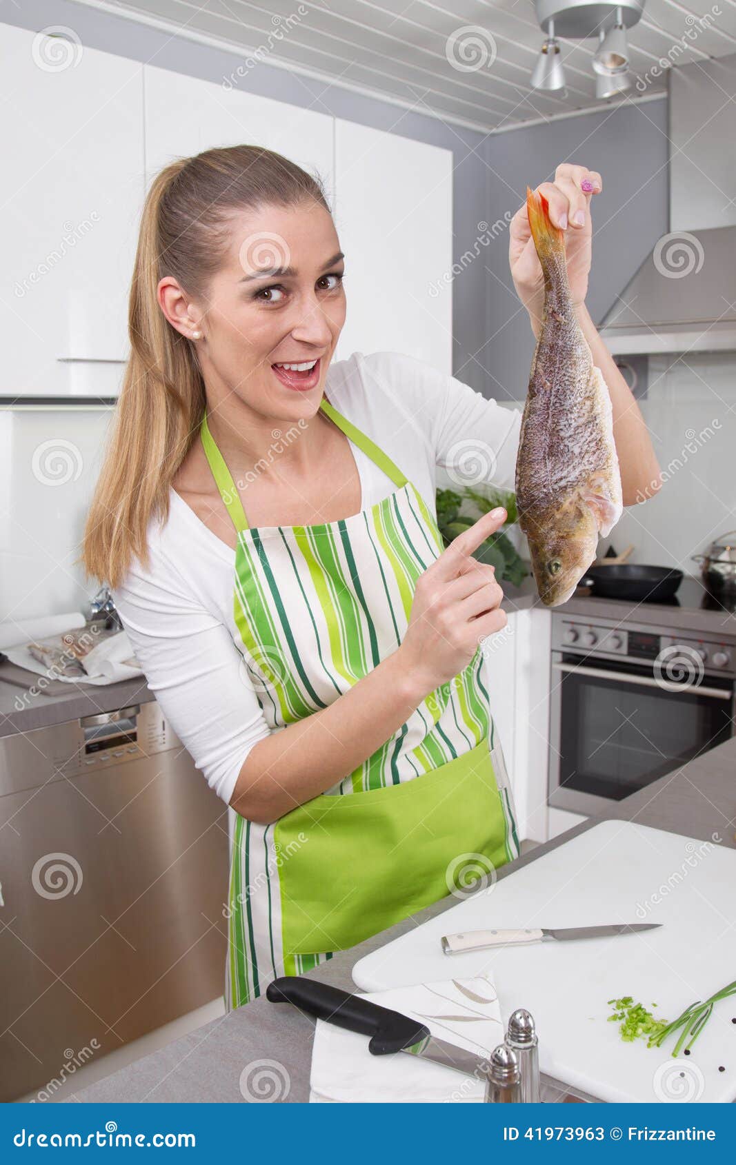 Woman in the Kitchen Preparing Fish Dinner with Perch - Humorous Stock ...