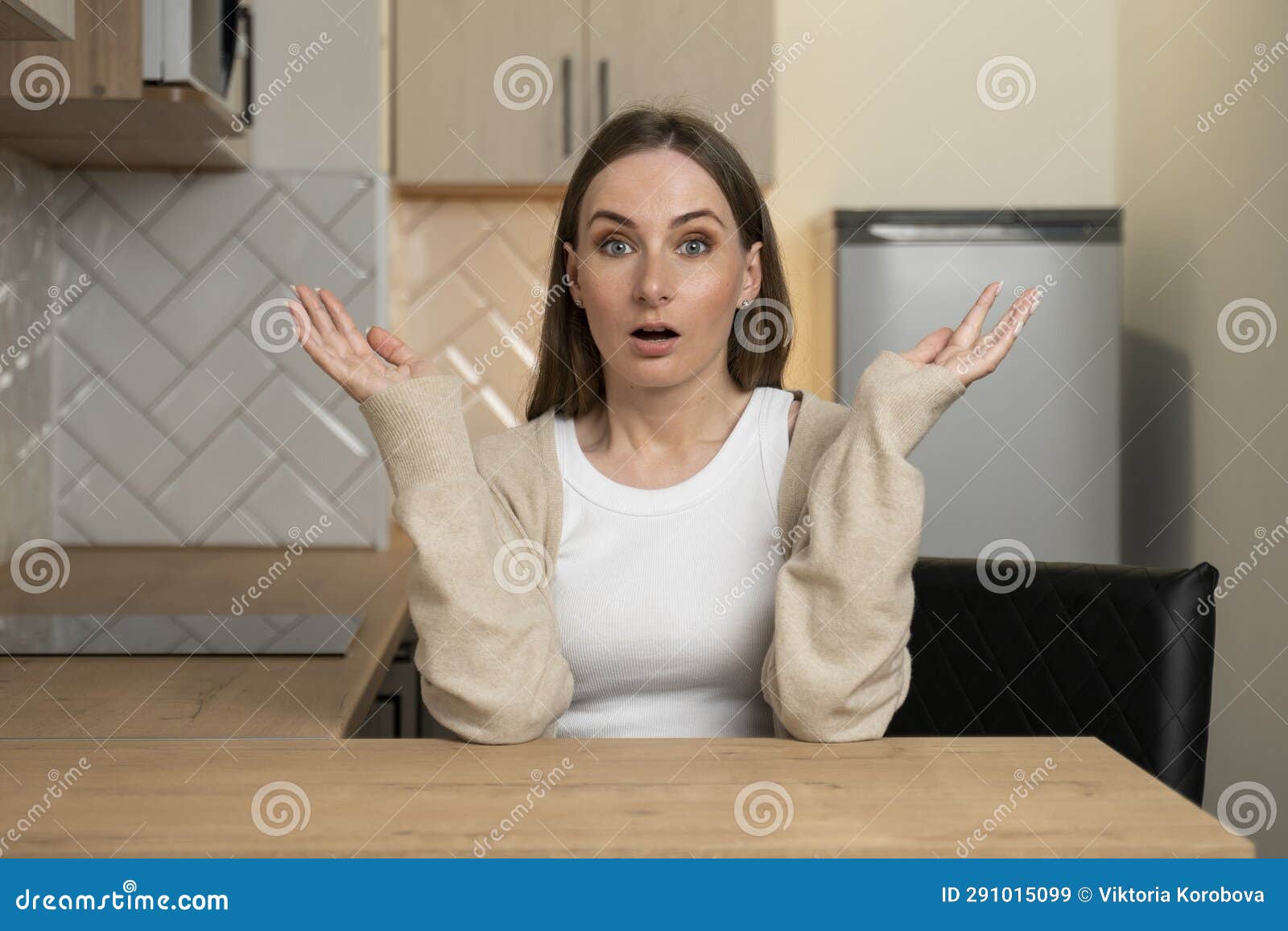 The Woman in the Kitchen is Scared and Folded with an Expression of ...