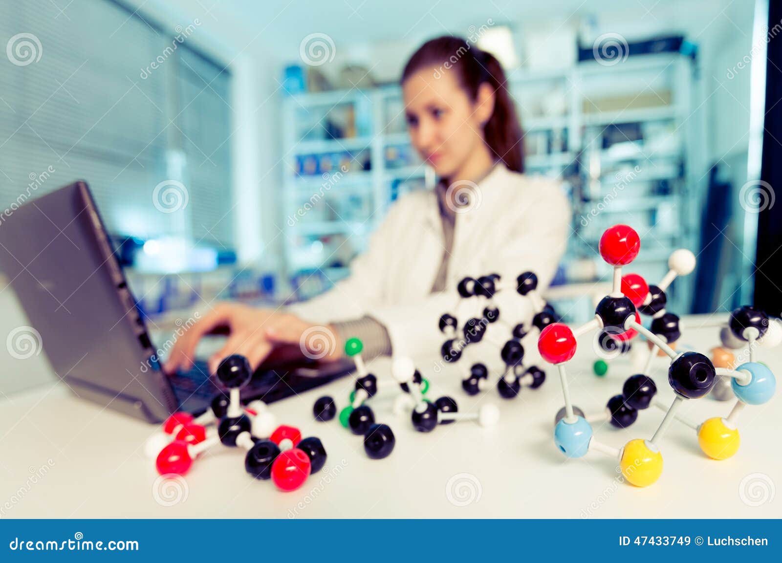 A Woman Laboratory Assistant Uses Computer for the Simulation Stock ...