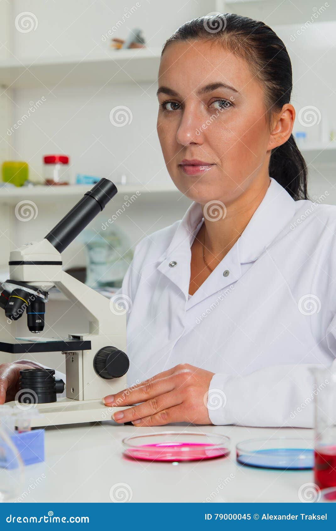Woman in a Laboratory Microscope with Microscope Slide in Hand Stock ...