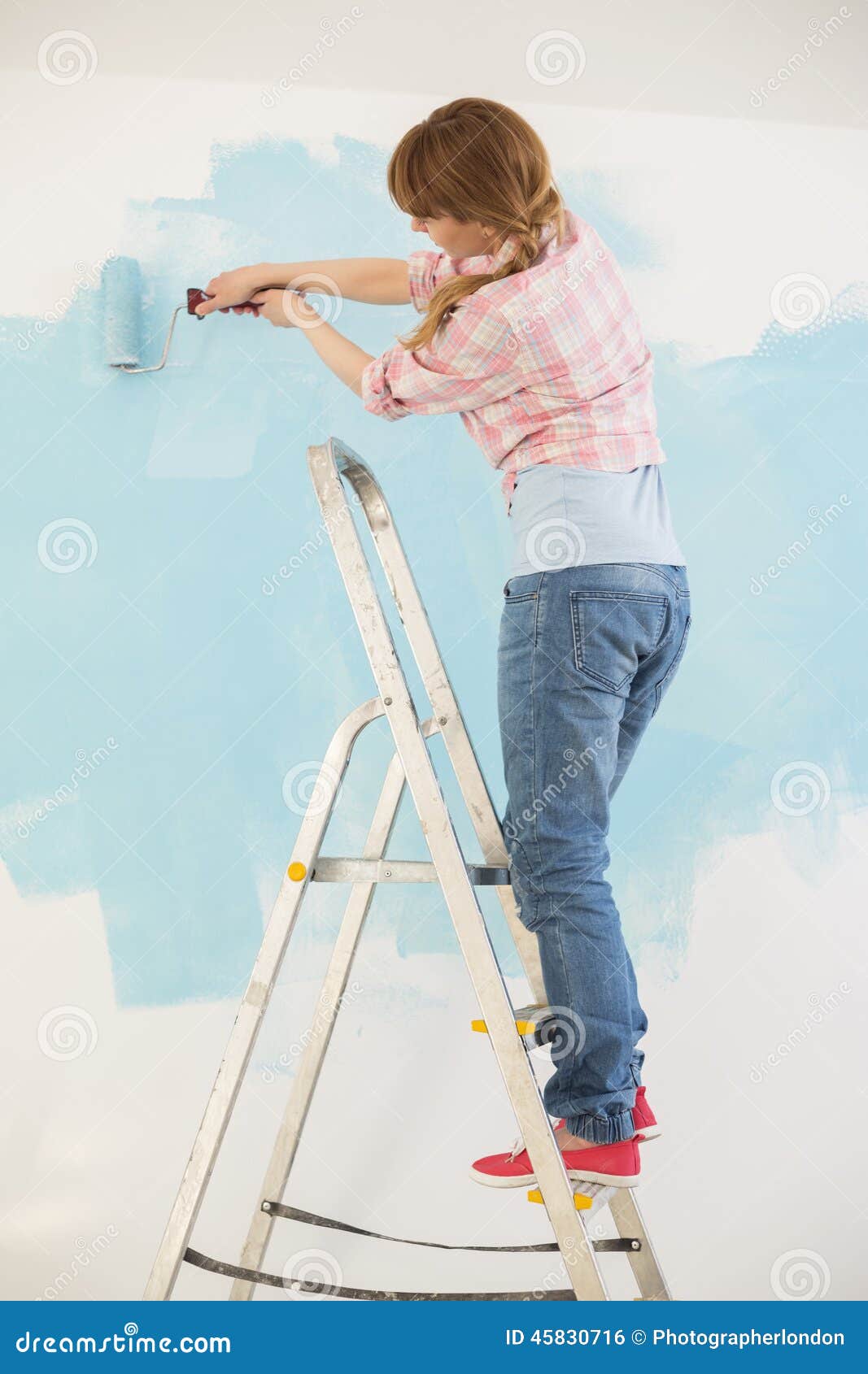 Woman on Ladder Painting Wall with Paint Roller Stock Photo - Image of ...