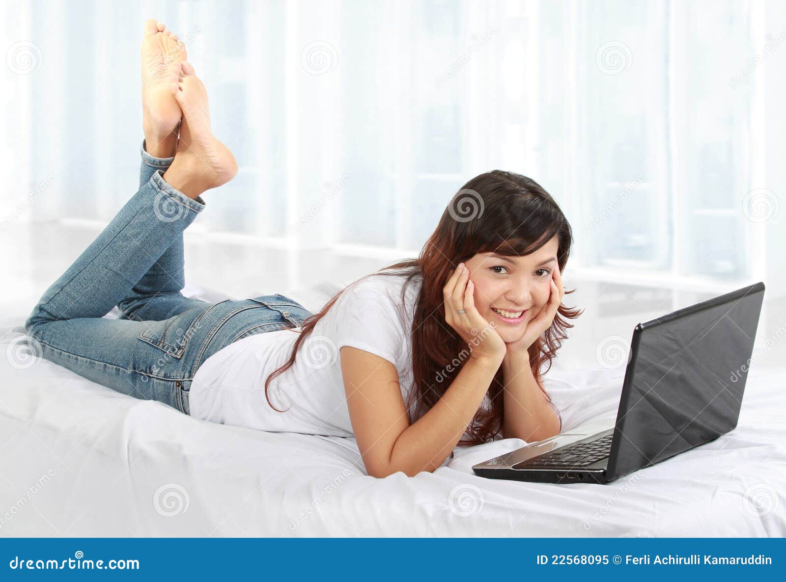 Woman with laptop on bed stock image. Image of internet - 22568095