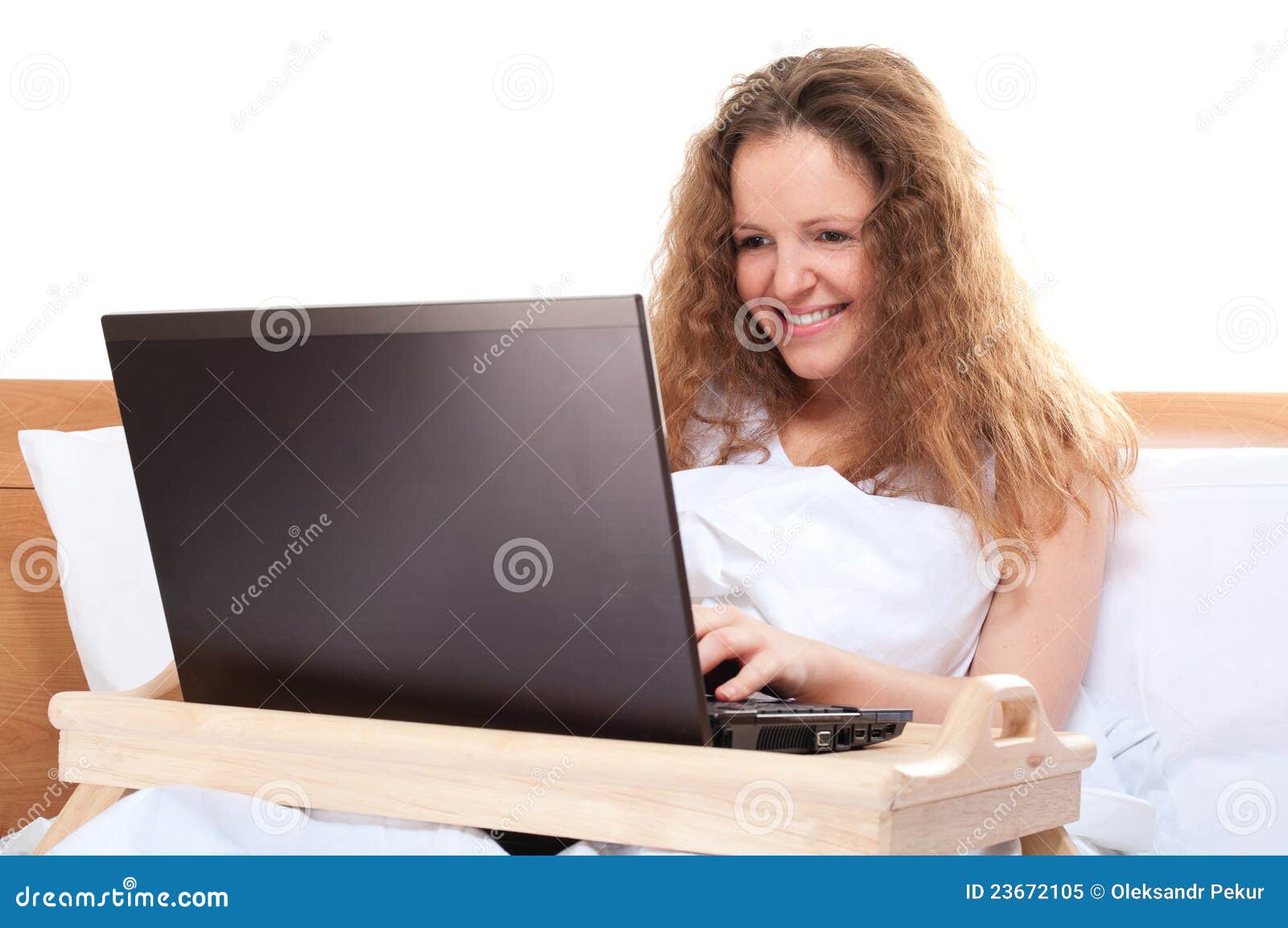 Woman with laptop in bed stock image. Image of tray, isolated - 23672105