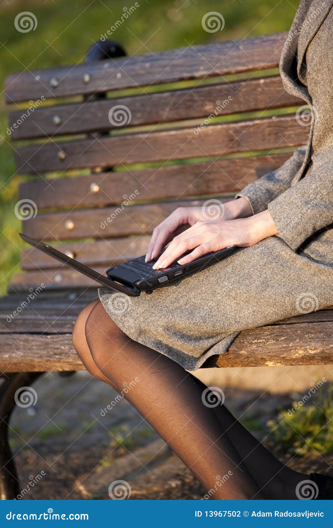 Woman with laptop on bench stock photo. Image of sitting - 13967502