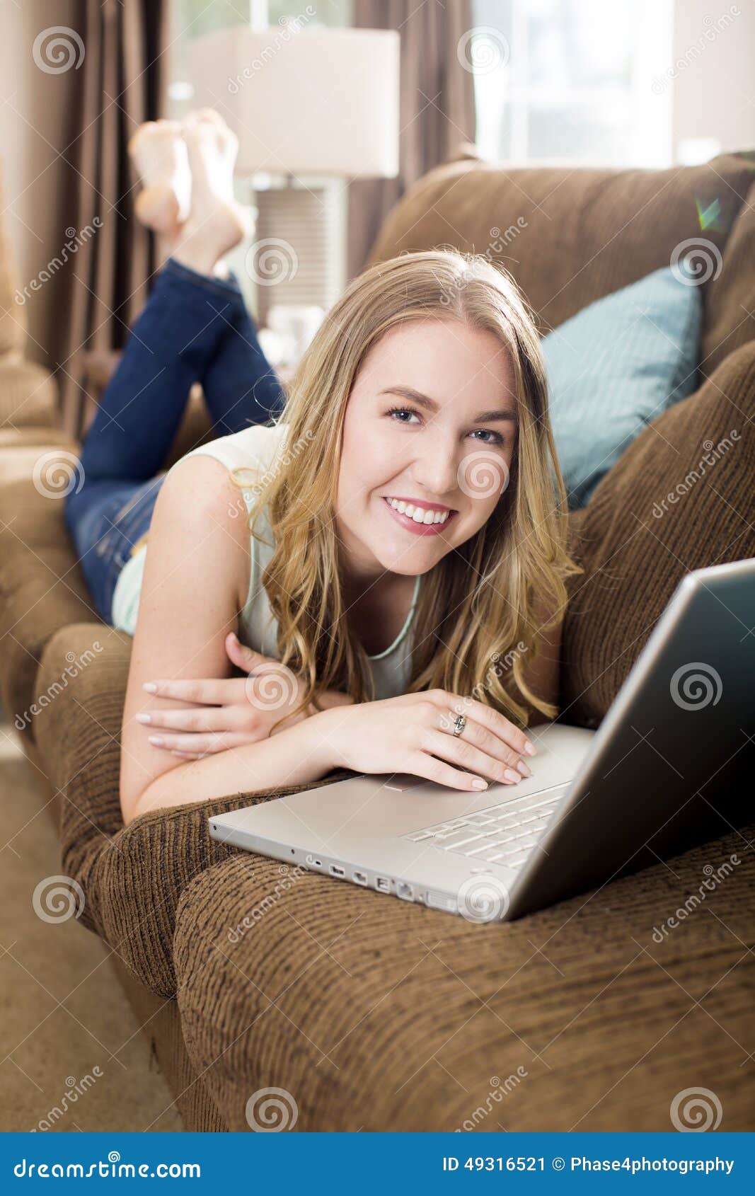 Woman laptop couch stock image. Image of device, pillows - 49316521