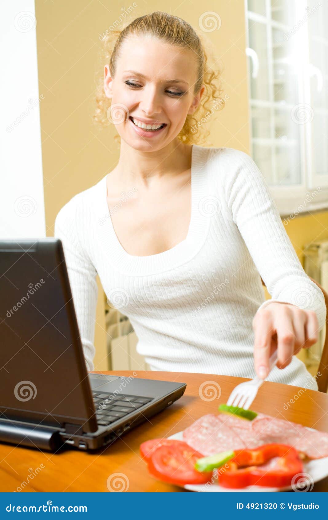 Woman with laptop, eating stock photo. Image of lunch - 4921320