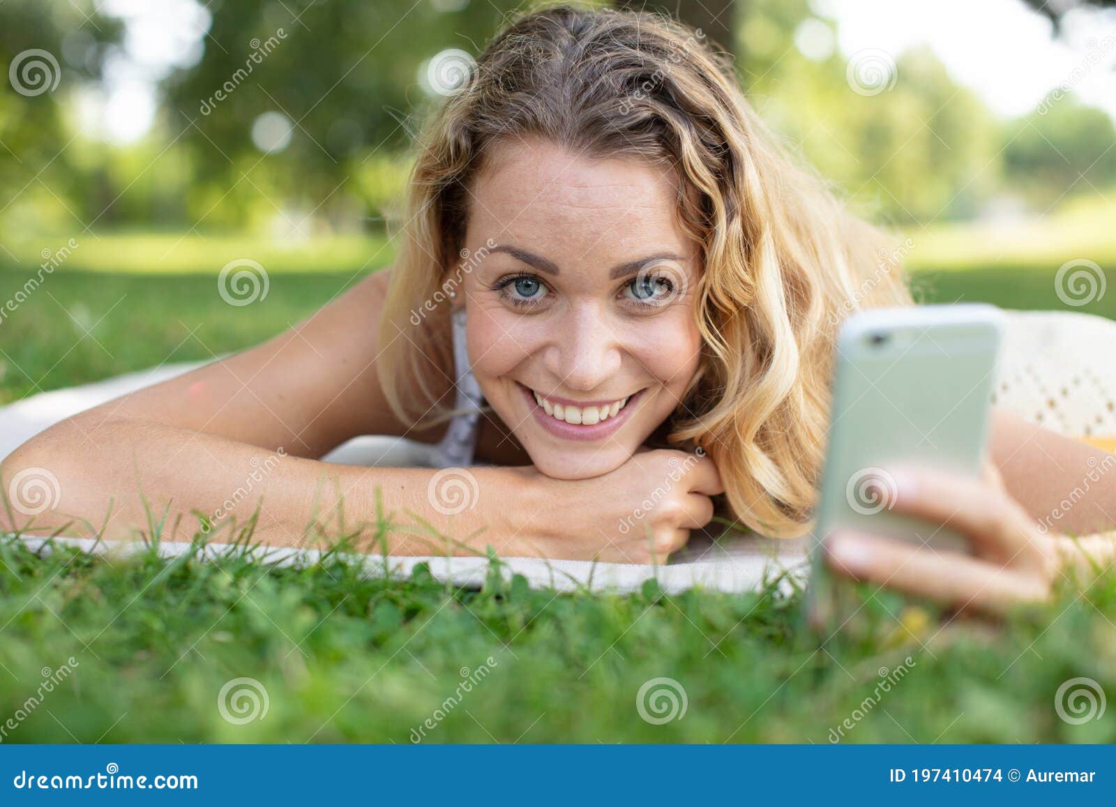 Woman Laughing while Using Smart Phone in Park Stock Photo - Image of ... Woman Laughing while Using Smart Phone in Park Stock Photo - Image of ...